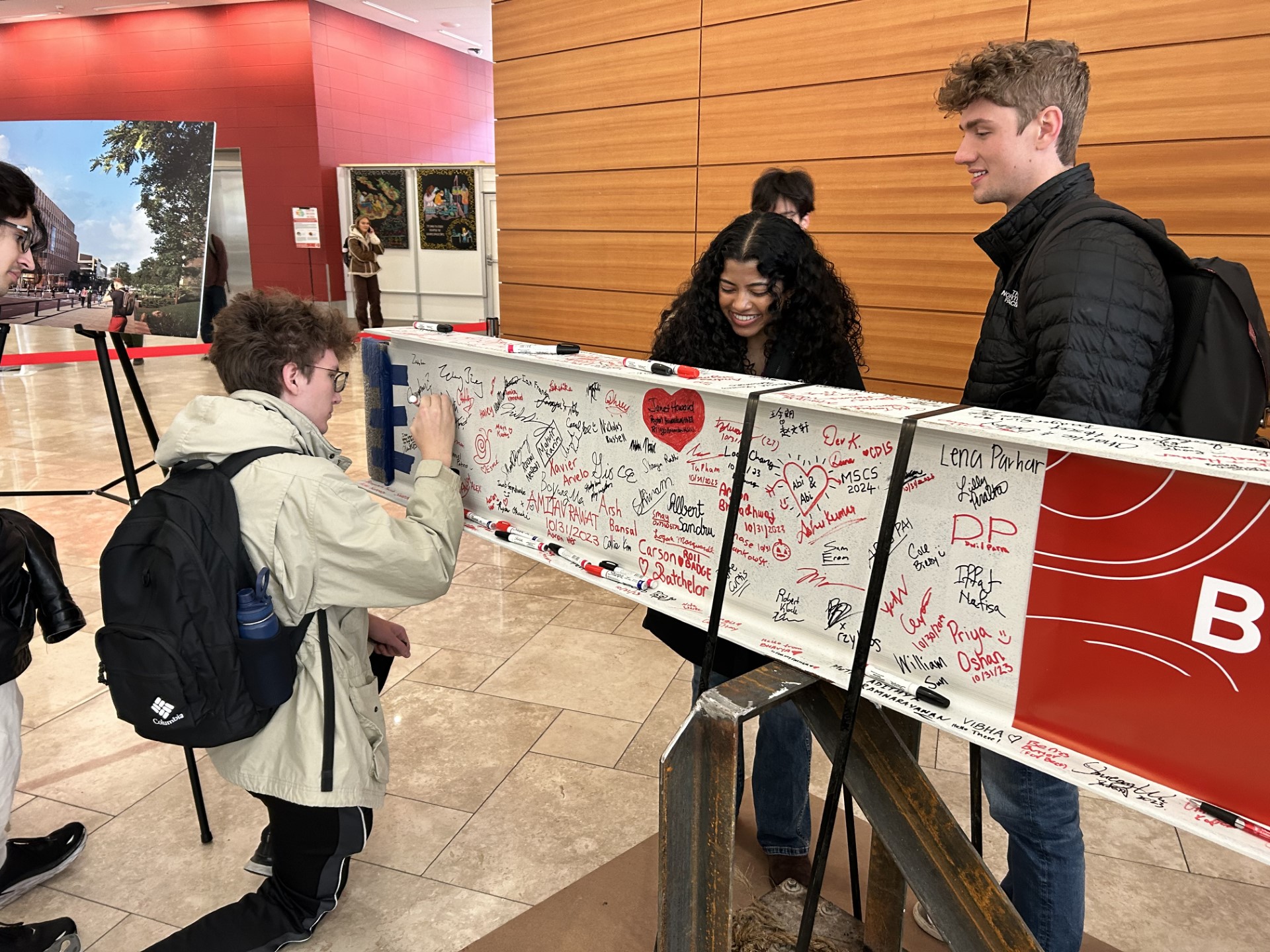 Beaming with pride: CDIS supporters make their mark on new building ...
